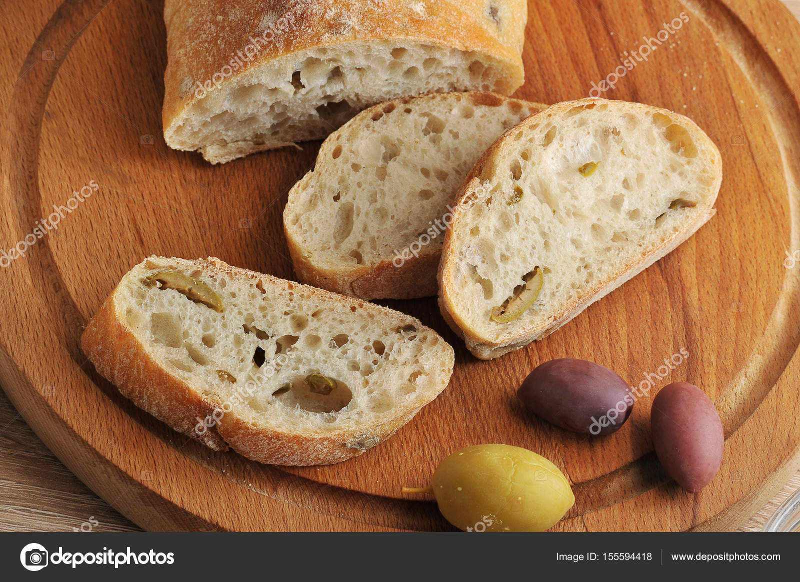 Sliced ciabatta bread on a round Board — Stock Photo © forden #155594418