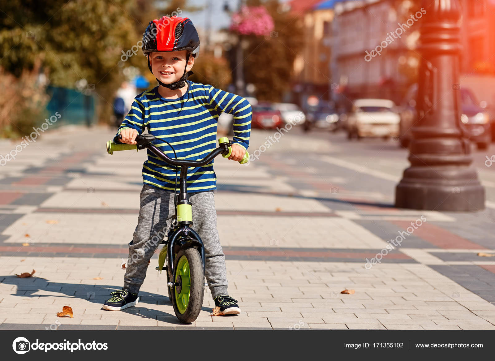 Happy boy ride a bicycle in city park Stock Photo by ©aleksey_rezin ...