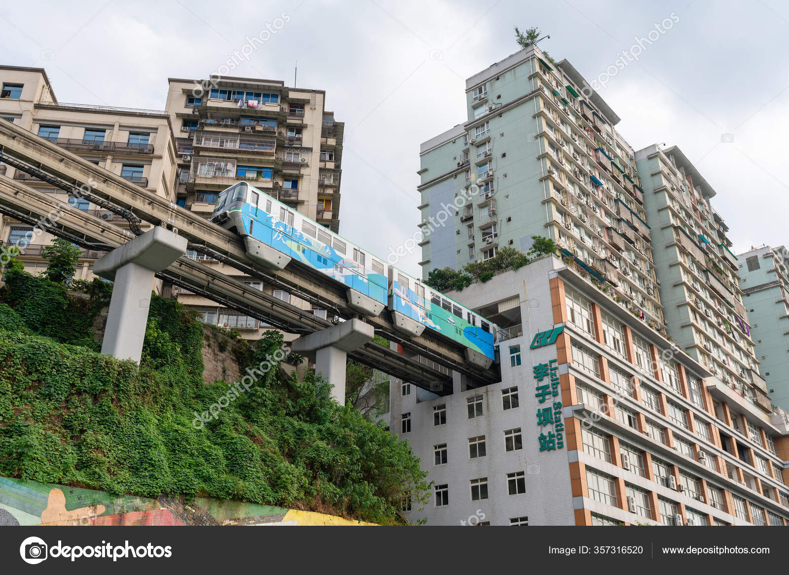 Train arriving at station within a residential building – Stock ...