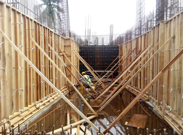 Timber form work and scaffolding used by construction workers at the ...