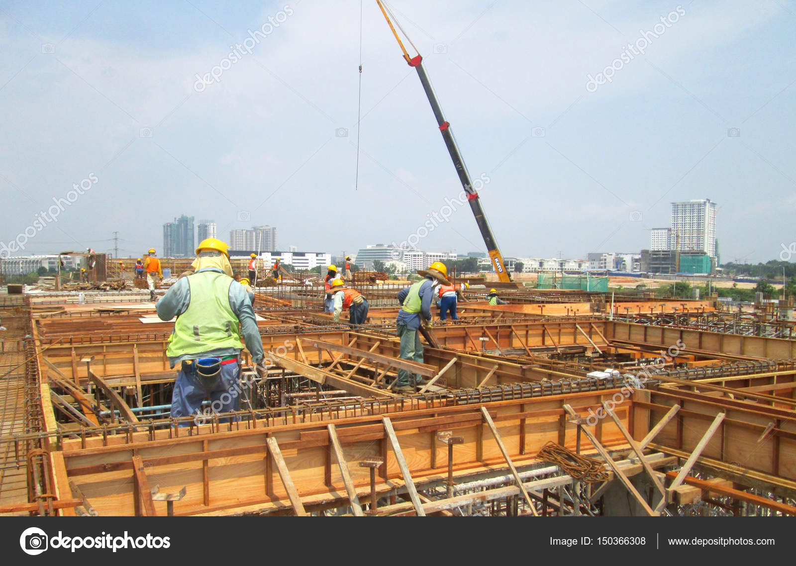 Construction workers fabricating timber form work at the construction ...