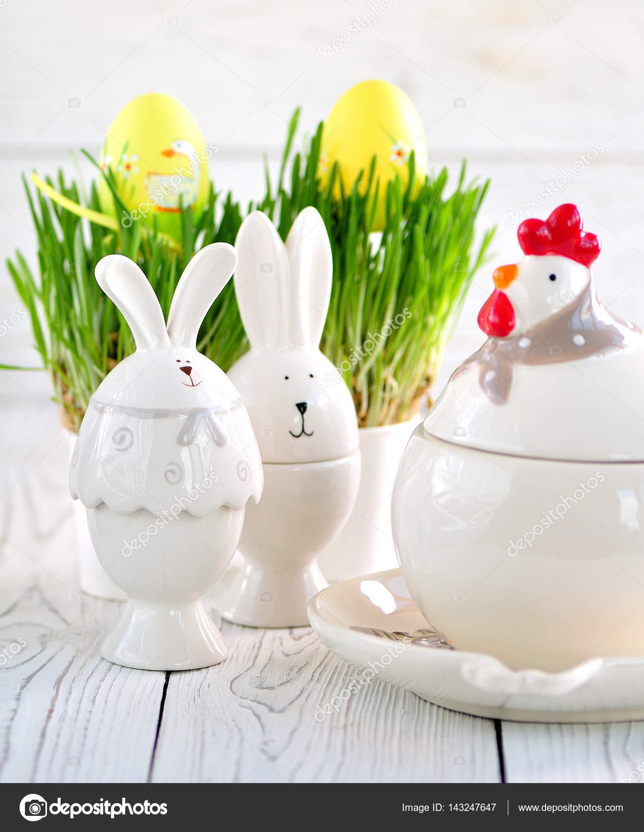 Easter dishes in the form of chickens and rabbits on a white wooden ...
