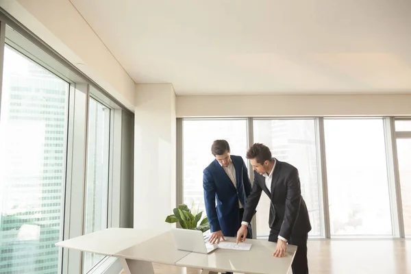 Real estate agent explaining room plan to client - Stock Image - Everypixel