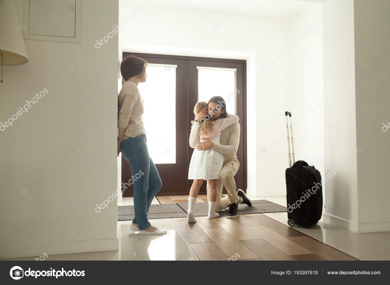 Sad daughter embracing dad leaving family saying goodbye to fath ...