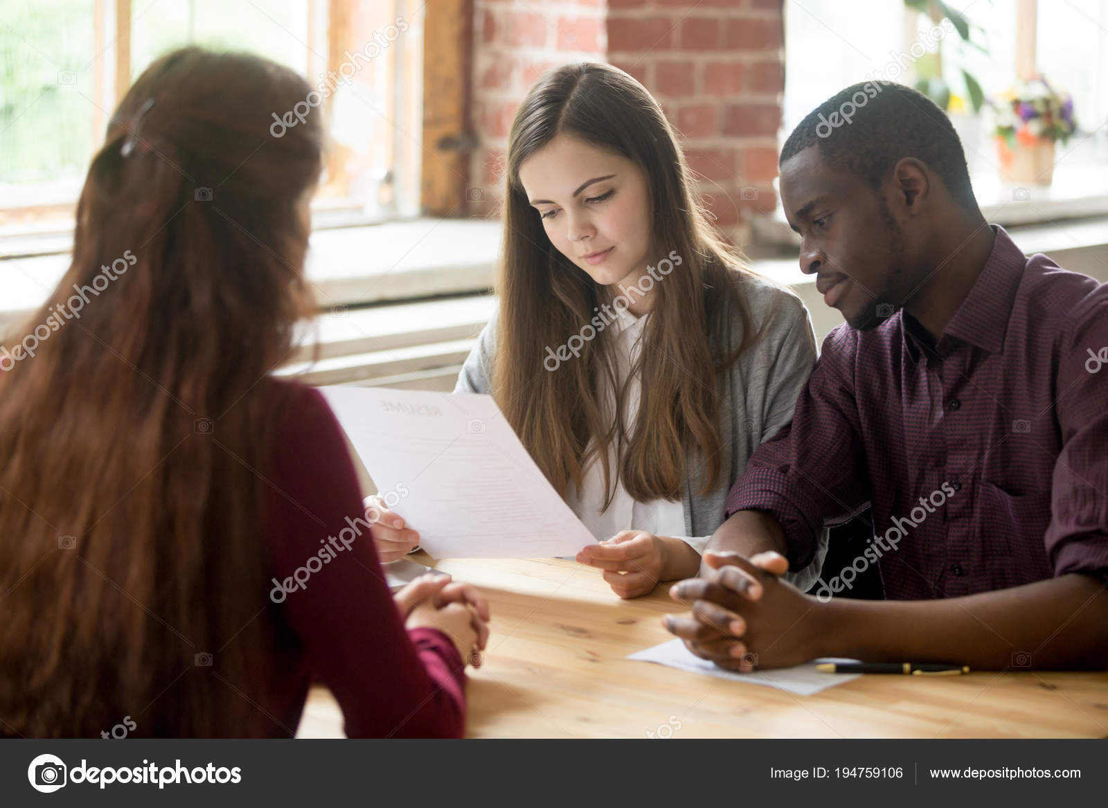 Multiracial managers reading applicant resume during hiring — Stock ... Multiracial managers reading applicant resume during hiring — Stock ...
