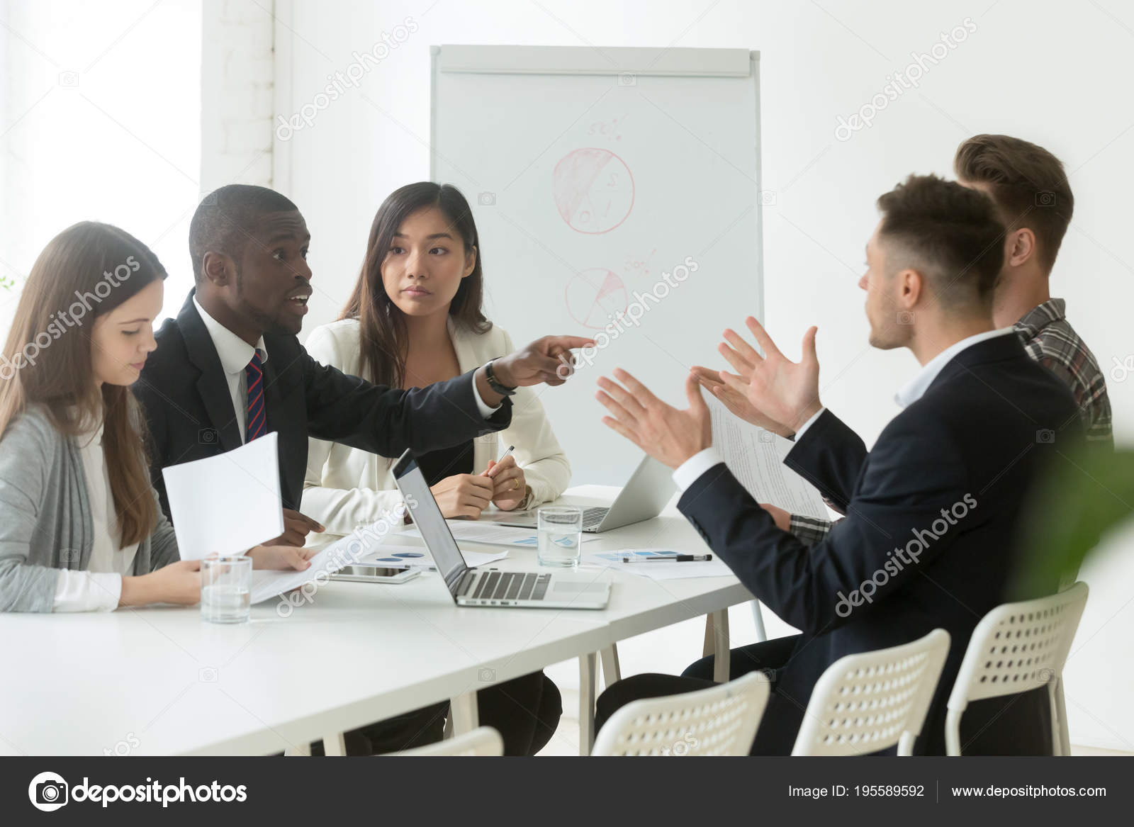 African worker disputing disagreeing with caucasian colleague du ...