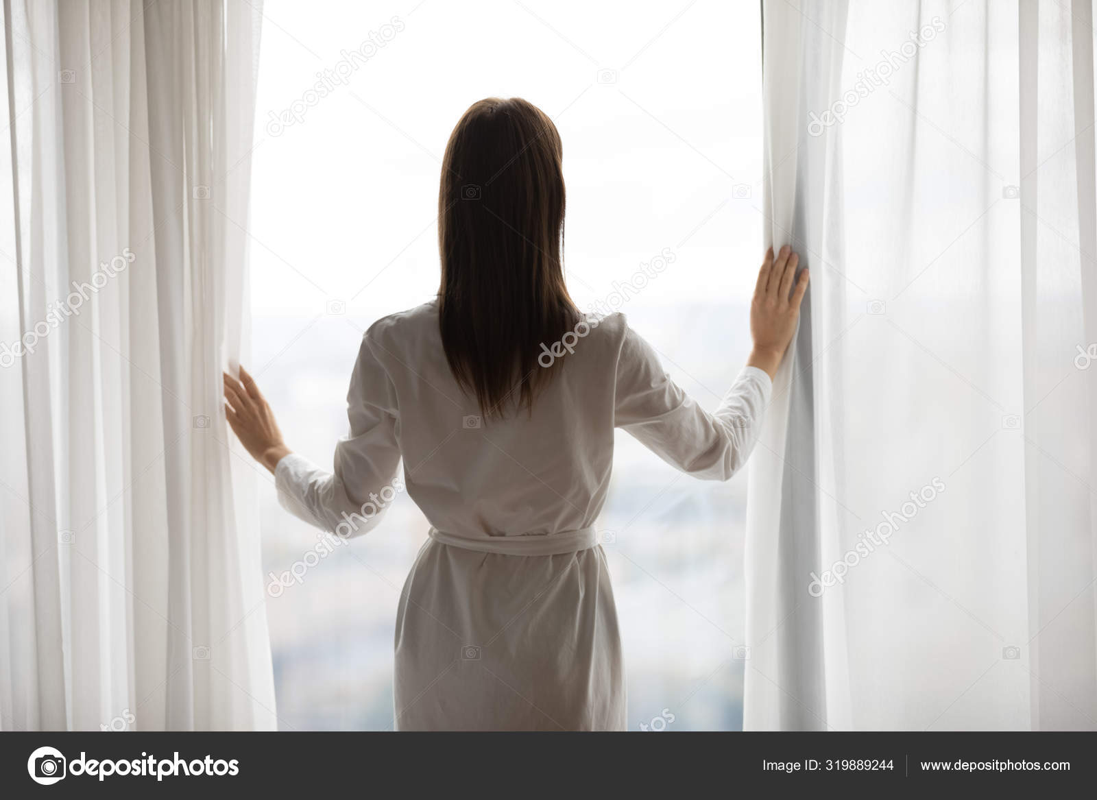 Young woman open curtain looking outside window, rear back view — Stock ...