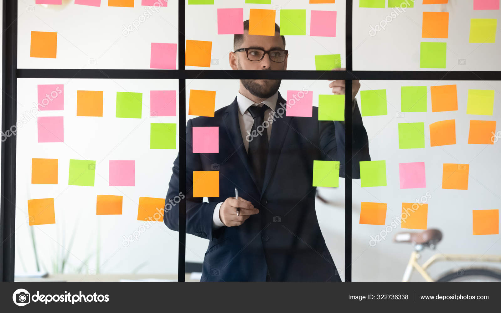 Concentrated young project manager working near kanban board. — Stock ...