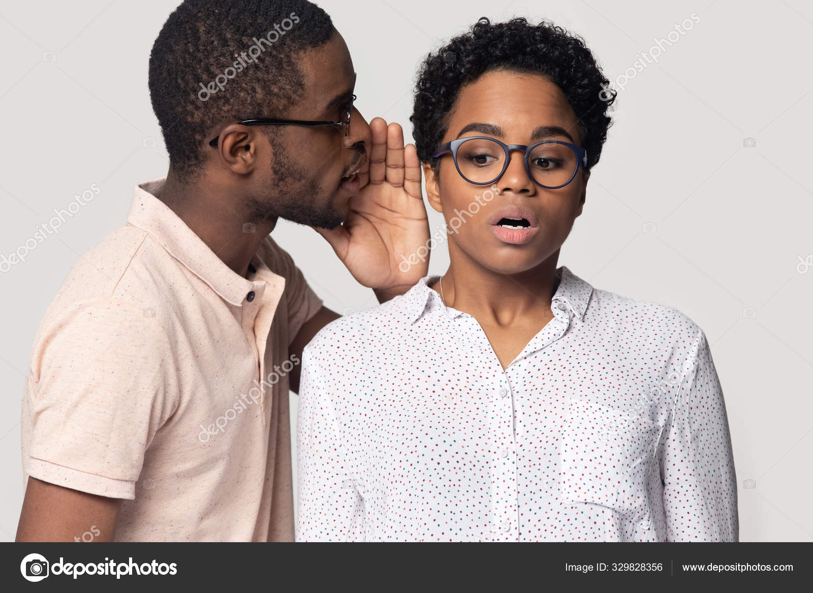 African guy whispering to ear of girl secret, studio shot — Stock Photo ...