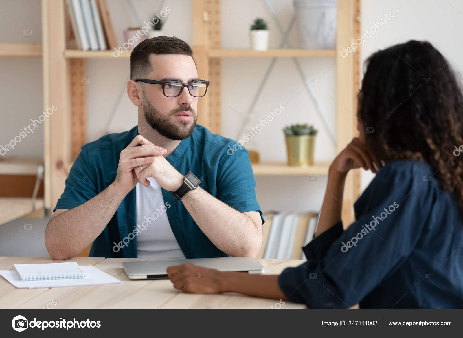 Focused young hr manager holding interview with african american ...