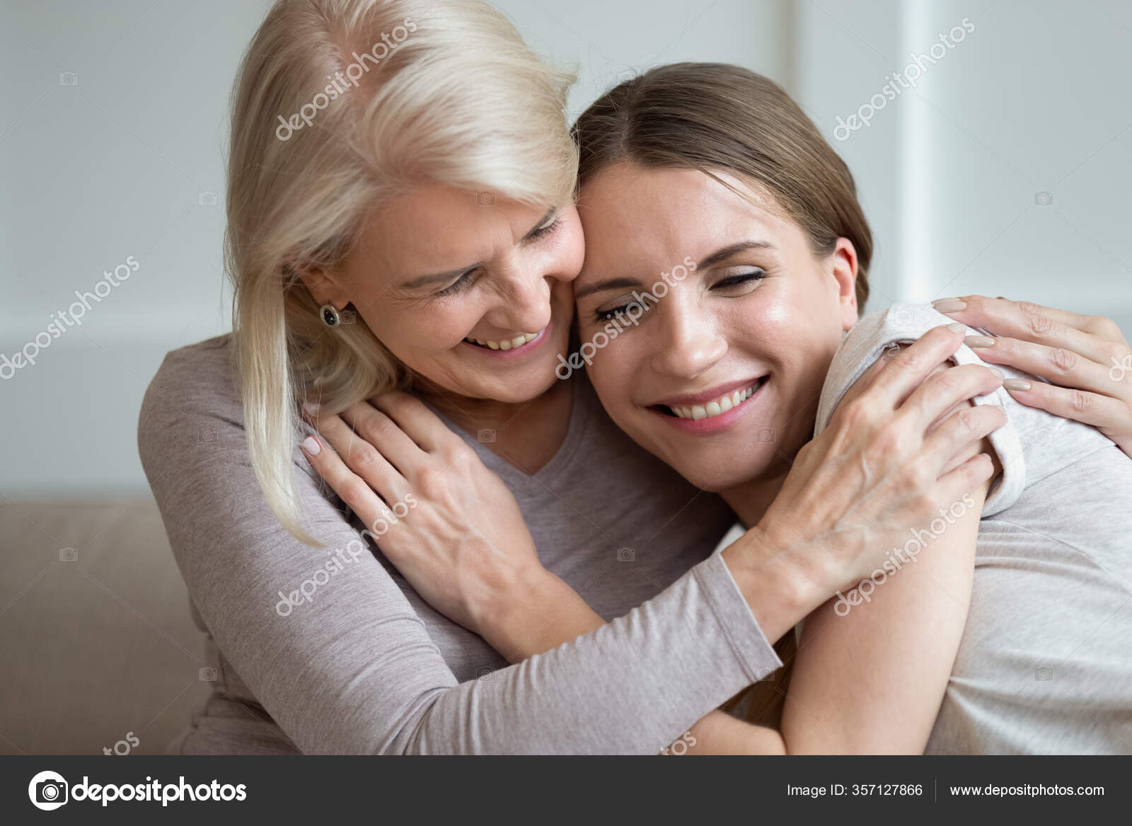 Happy Smiling Older Mother And Adult Daughter Hugging And Laughing