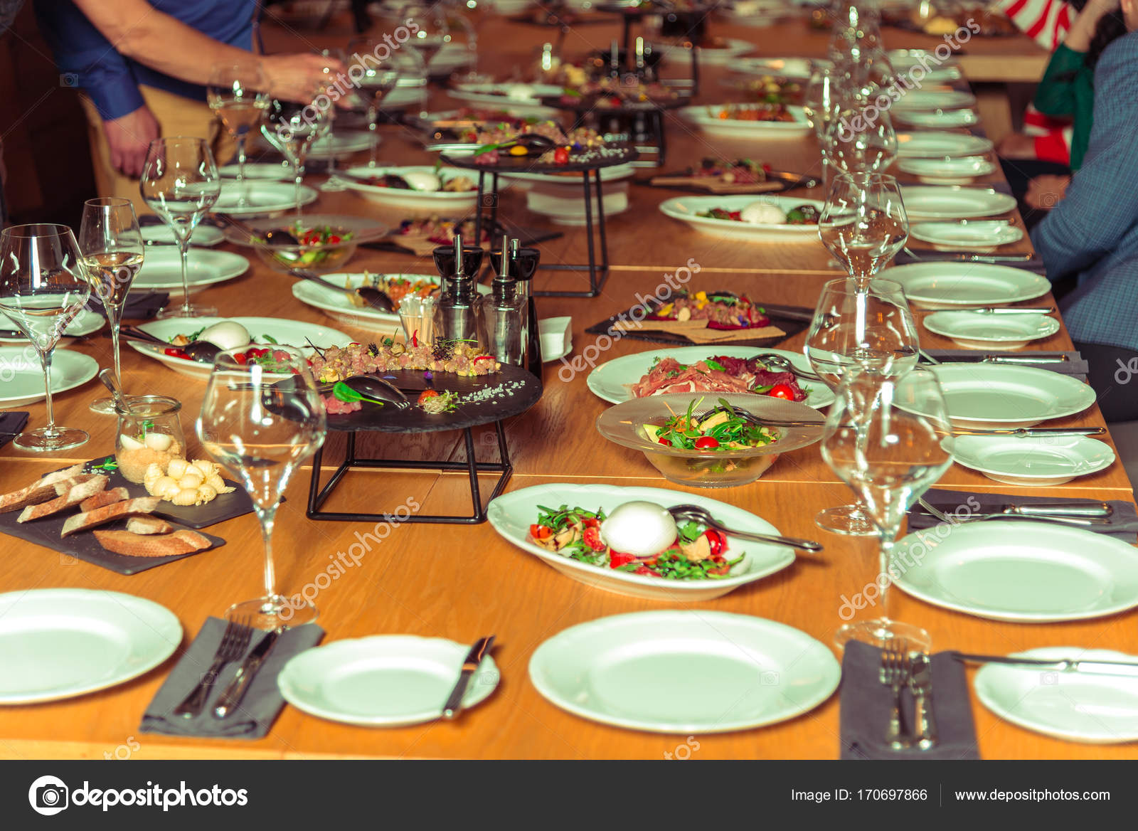 A table with plates and food for a big company — Stock Photo © liukov ...
