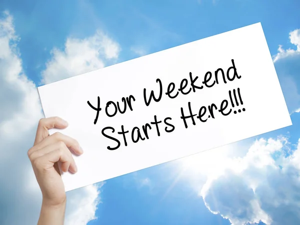 Your Weekend Starts Here!!! Sign on white paper. Man Hand Holdin ...