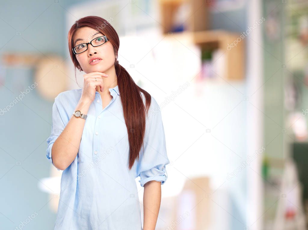 Concentrated chinese woman thinking Stock Photo by ©kues 128830756