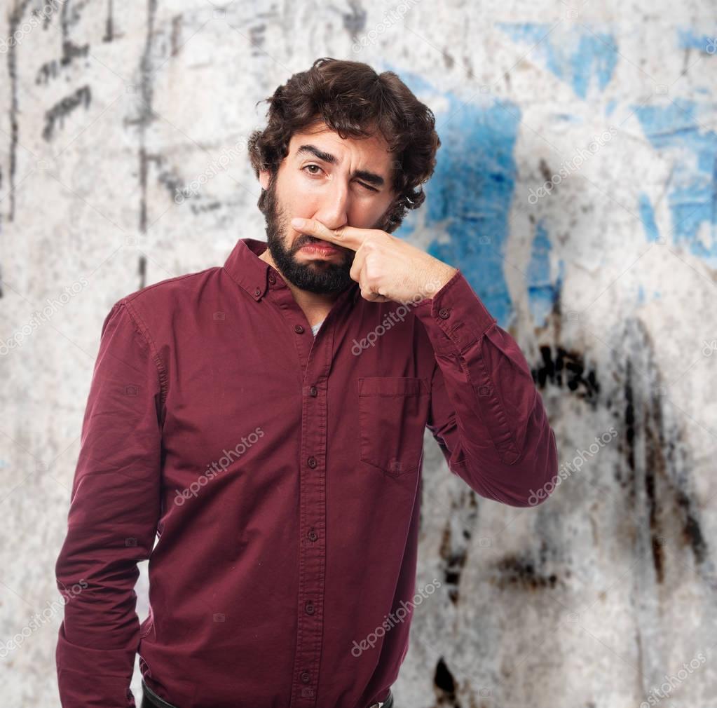 Sad young man smell bad Stock Photo by ©kues 128849996