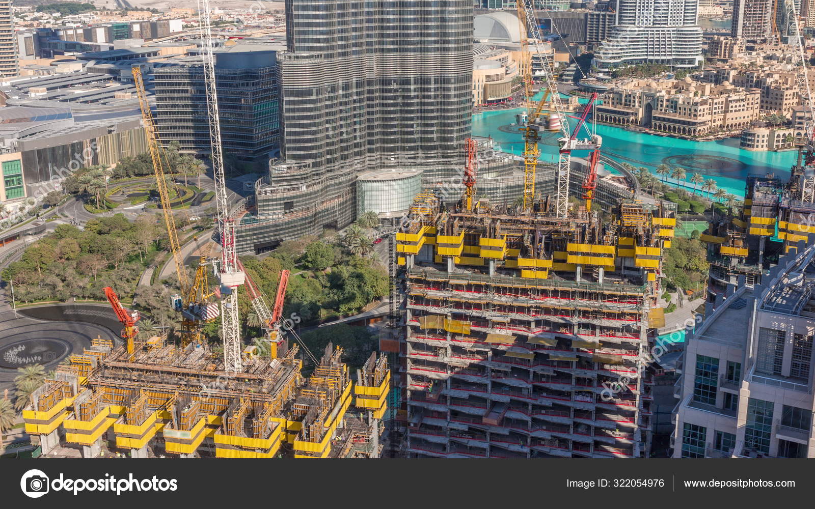 Aerial view of a skyscraper under construction with huge cranes ...