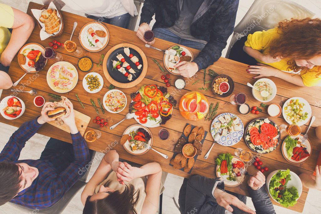 People eat healthy meals and talk at served table dinner party — Stock ...