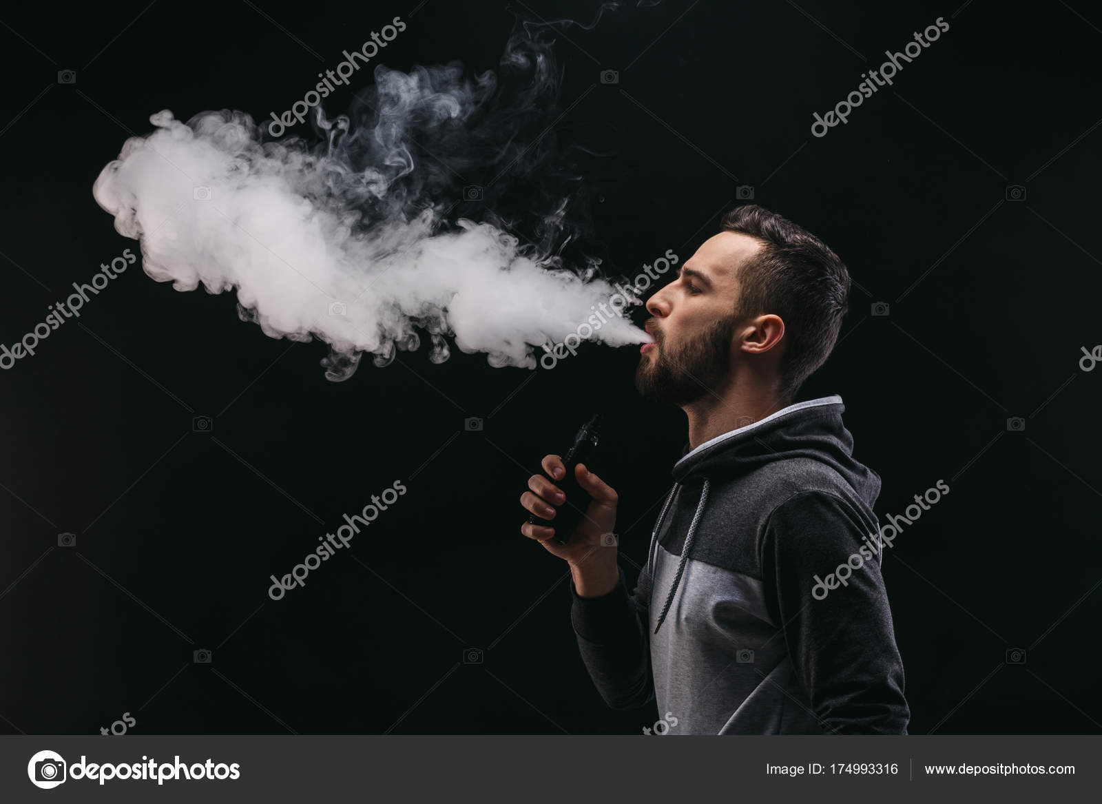 Young man vaping e-cigarette with smoke on black Stock Photo by ©Milkos ...