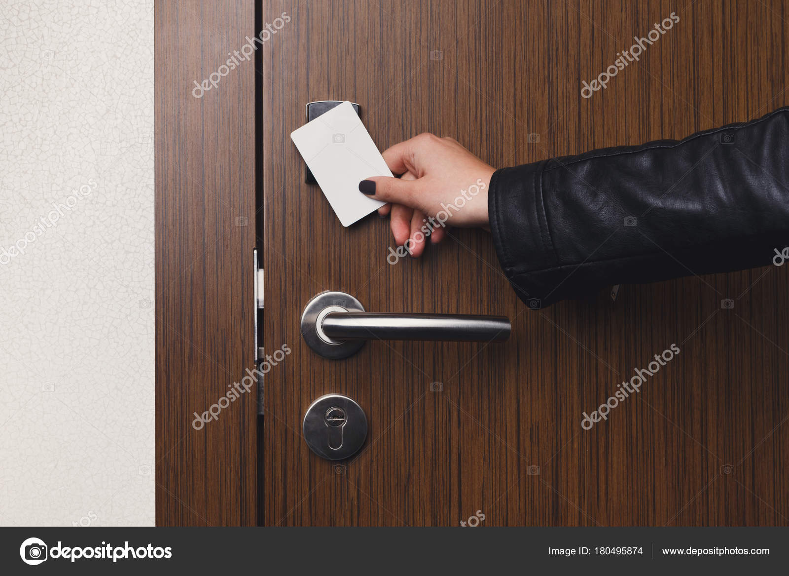 Hand inserting key card in electronic lock Stock Photo by ©Milkos 180495874