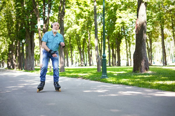 Senior man roller skating outdoors Stock Photo by ©Milkos 182455658