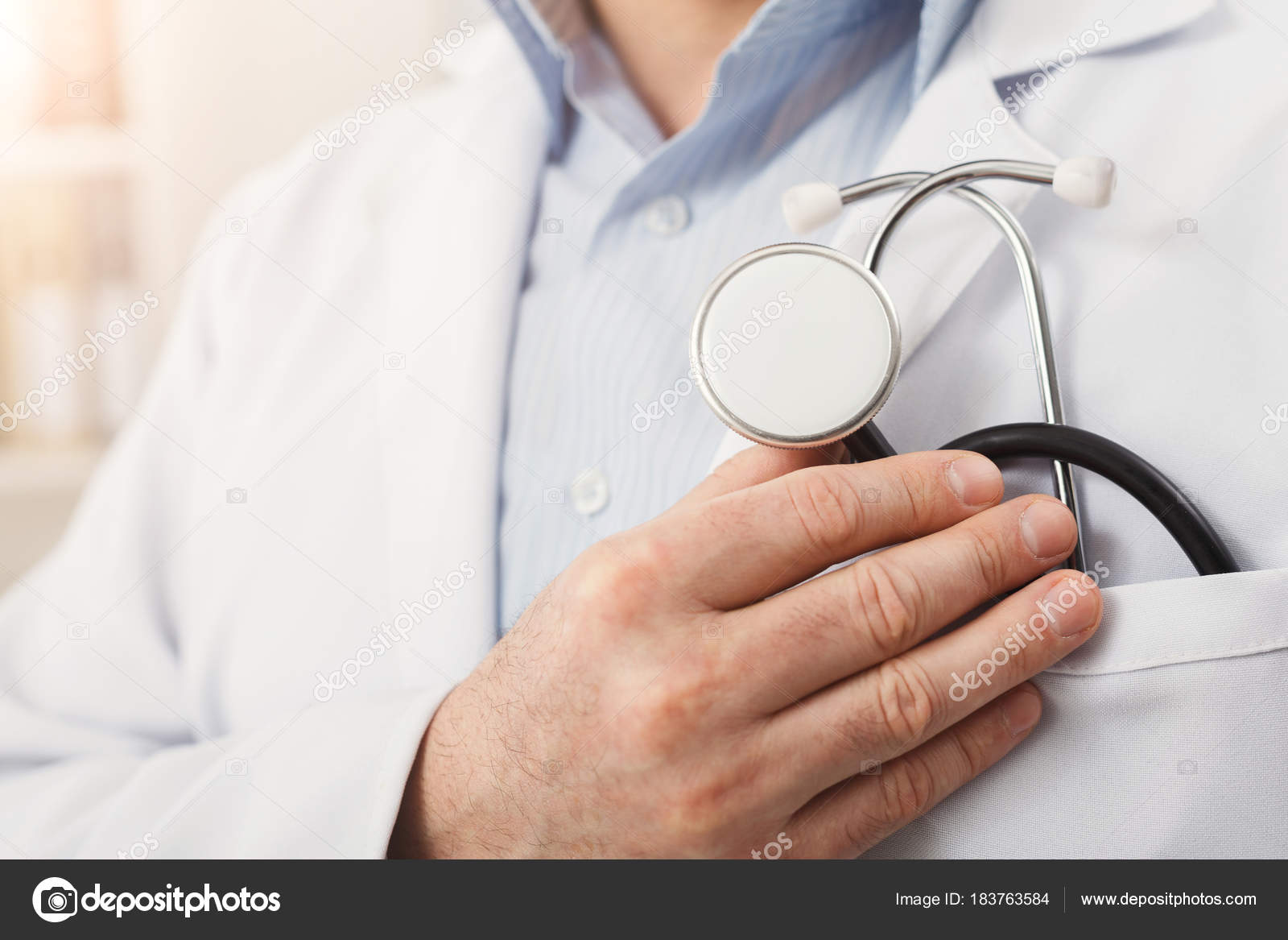 Male hand holding stethoscope closeup — Stock Photo © Milkos #183763584