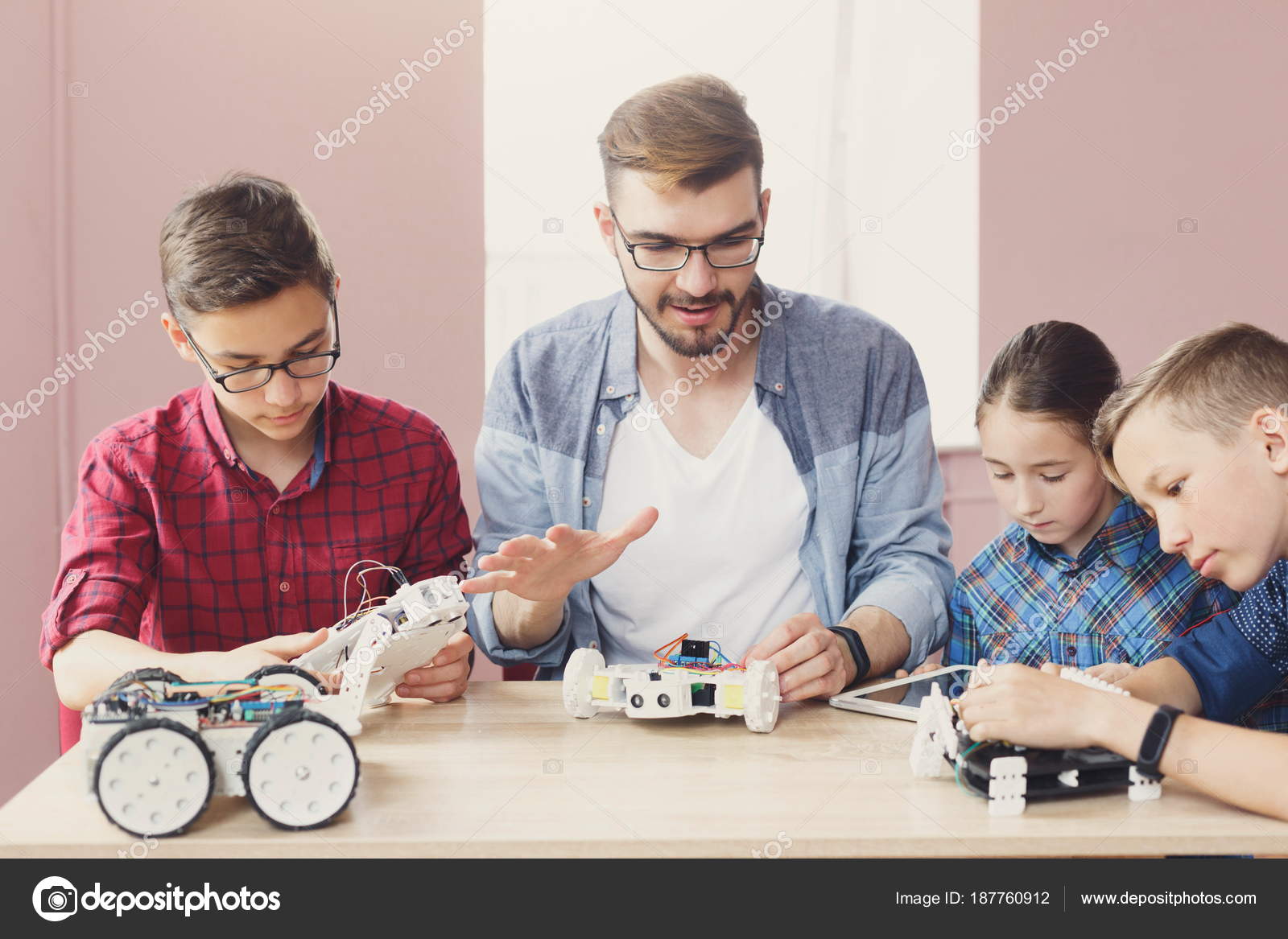 Stem education. Kids creating robots with teacher Stock Photo by ...