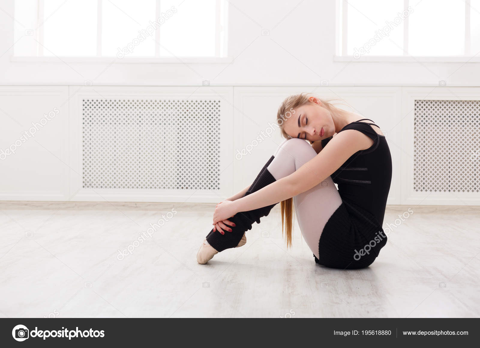 Classical ballet dancer sitting in white training class Stock Photo by ...