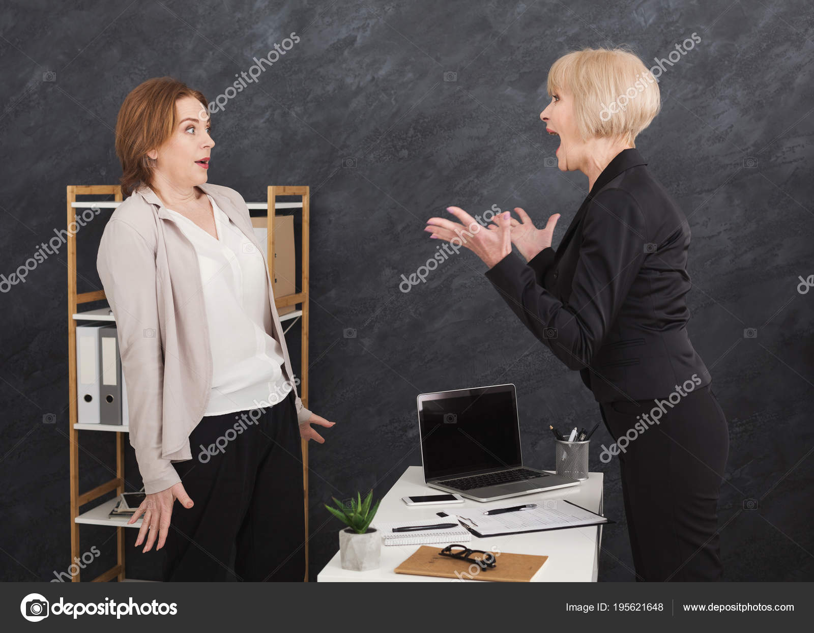Angry middle aged boss yelling at young employee — Stock Photo © Milkos ...