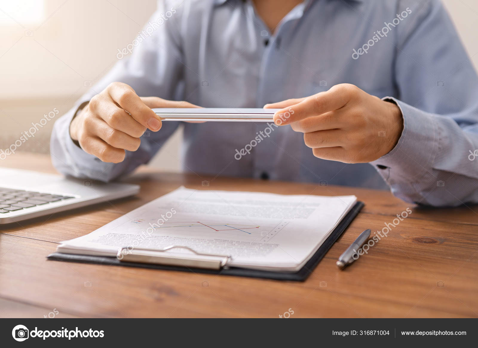 Man holding smartphone in horizontal orientation using scanner app ...