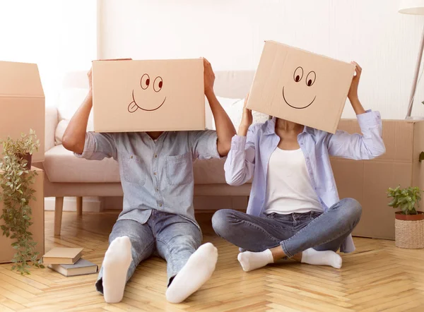 Couple With Moving Boxes On Head Having Fun At Home - Stock Image ...