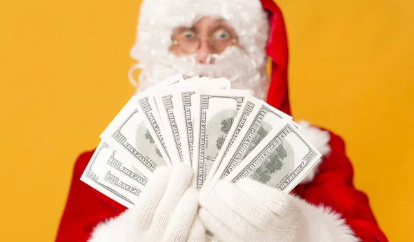 Rich Santa Claus showing many dollar banknotes on orange Stock Photo by ...