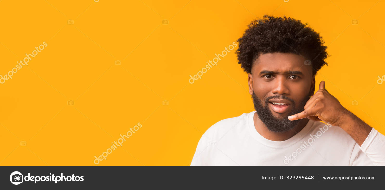 Persistent afro guy showing call me gesture over orange background ...