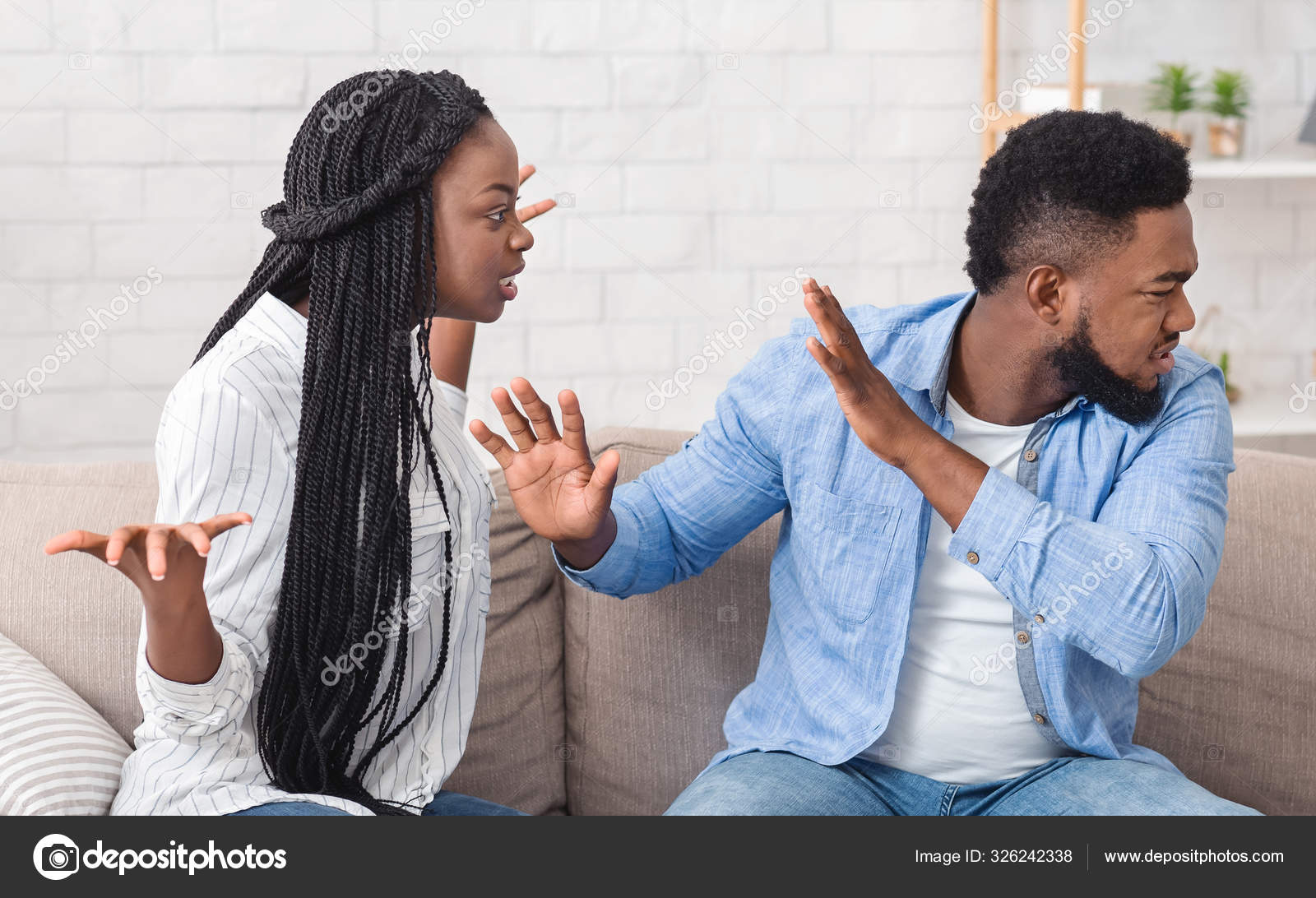 Black millennial couple arguing on sofa at home Stock Photo by ©Milkos ...