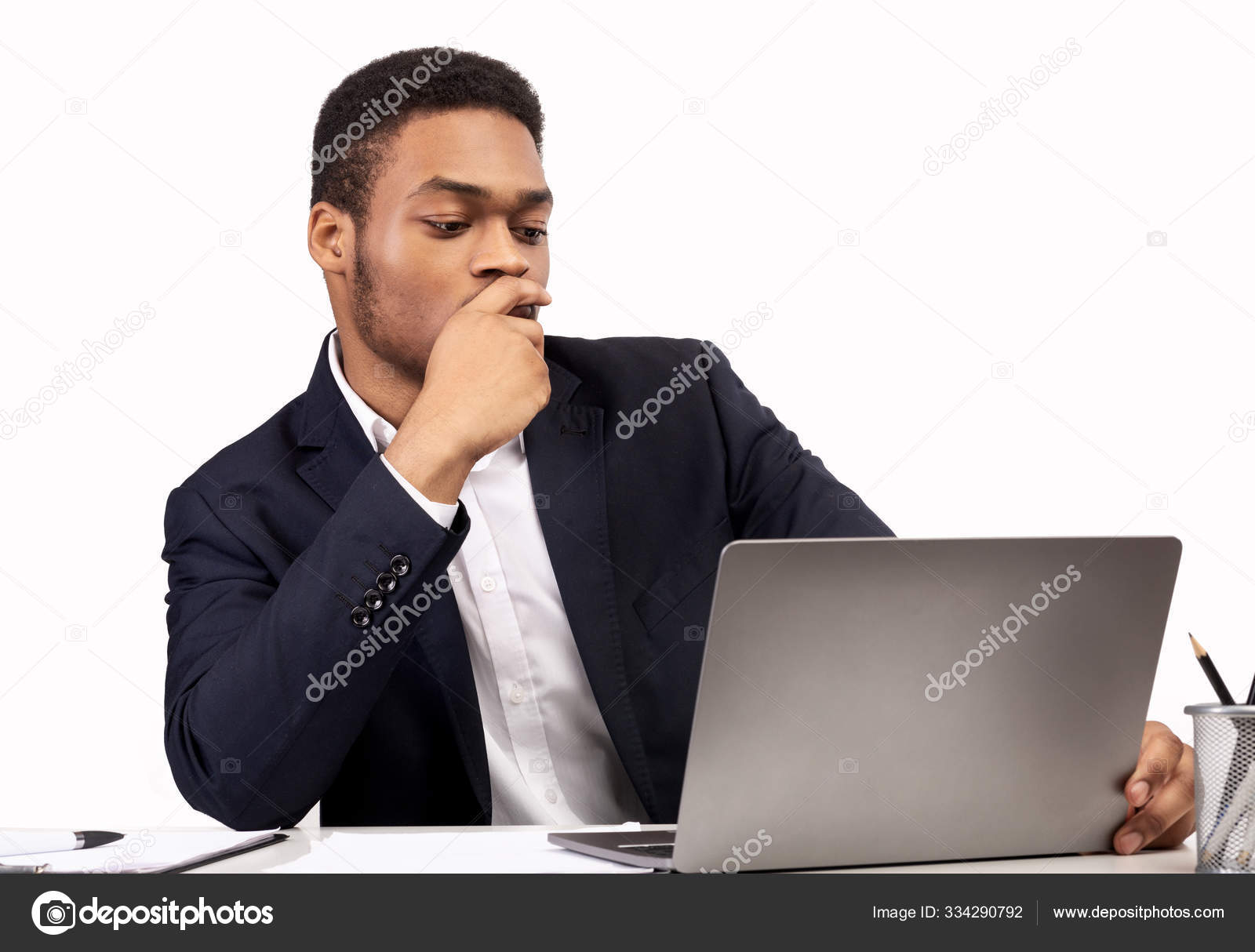 Black guy working on his laptop at office — Stock Photo © Milkos #334290792