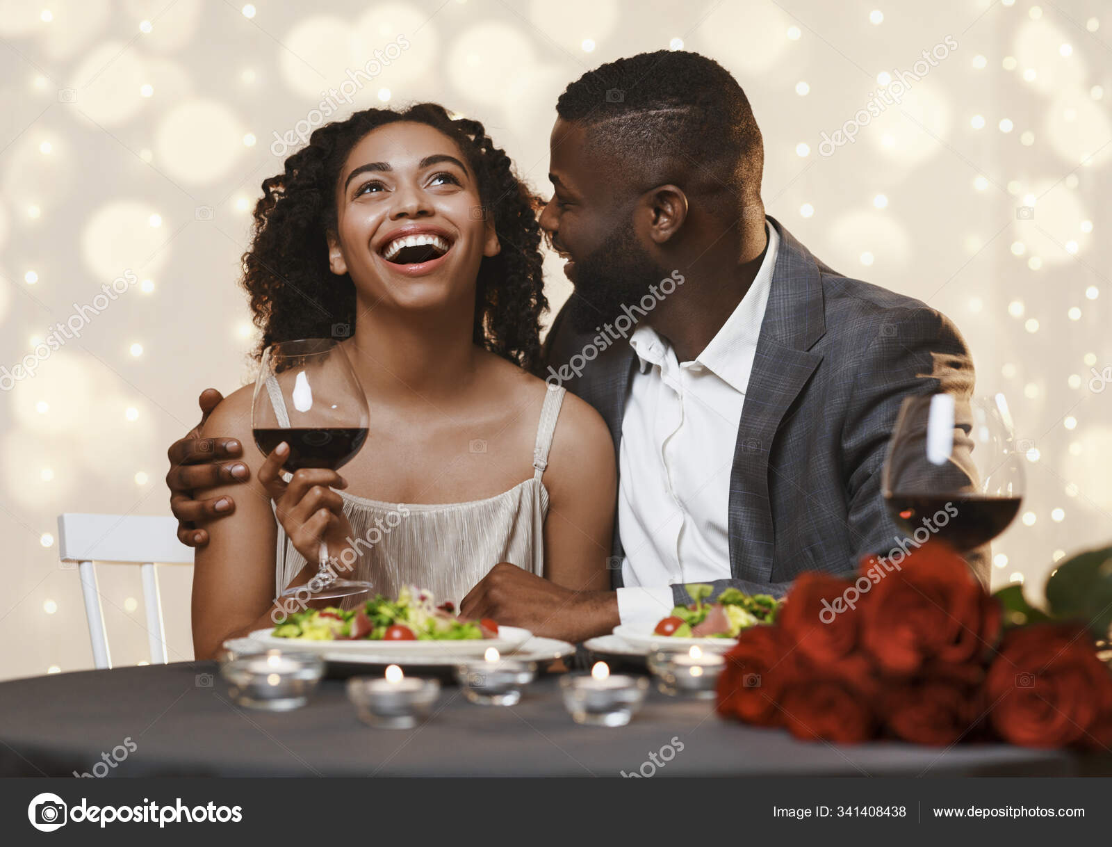 Romantic black man courting his pretty girlfriend in restaurant Stock ...