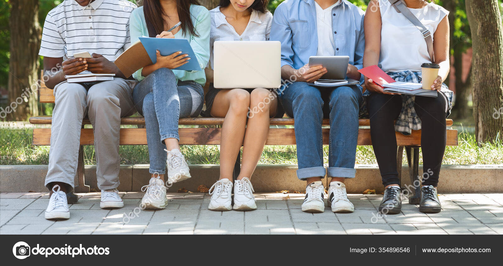 College Students Sitting On Bench