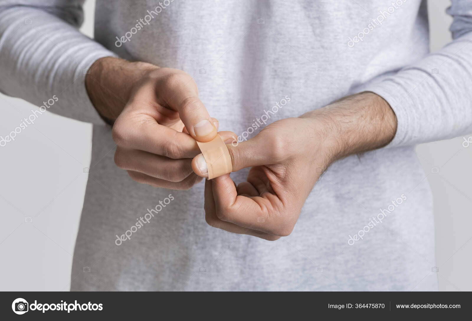 Man wrapping wound on finger with band-aid — Stock Photo © Milkos ...