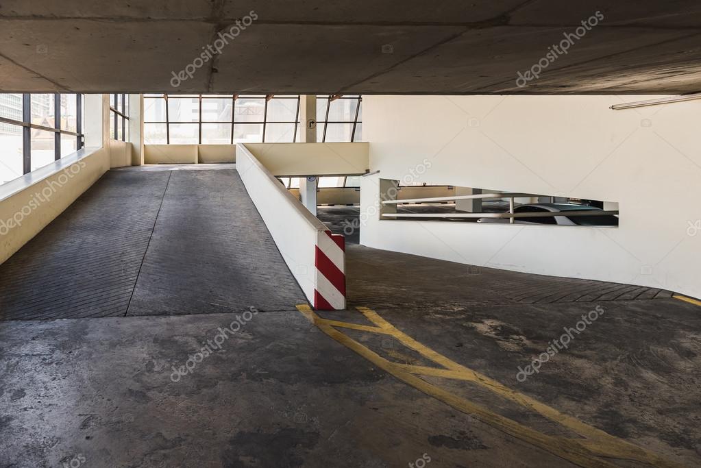 Empty parking deck with ramp Stock Photo by ©khongkitwiriyachan 125190540