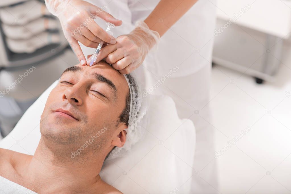 Serene man getting botox injection Stock Photo by ©iakovenko123 130392014