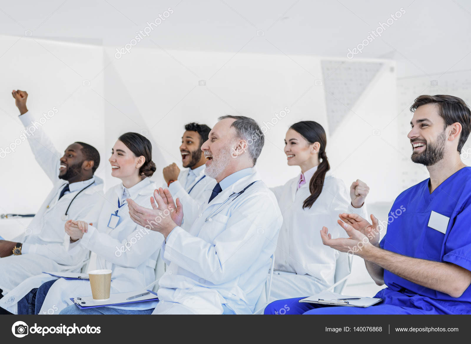 Happy doctors clapping hands on seminar Stock Photo by ©iakovenko123 ...