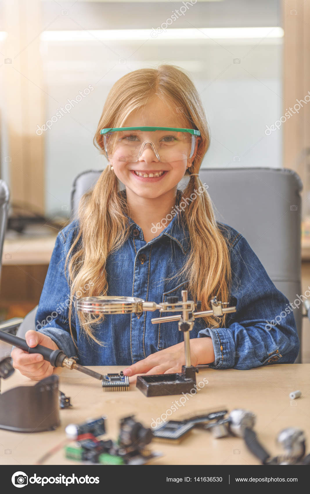Happy smiling little female inventor Stock Photo by ©iakovenko123 141636530
