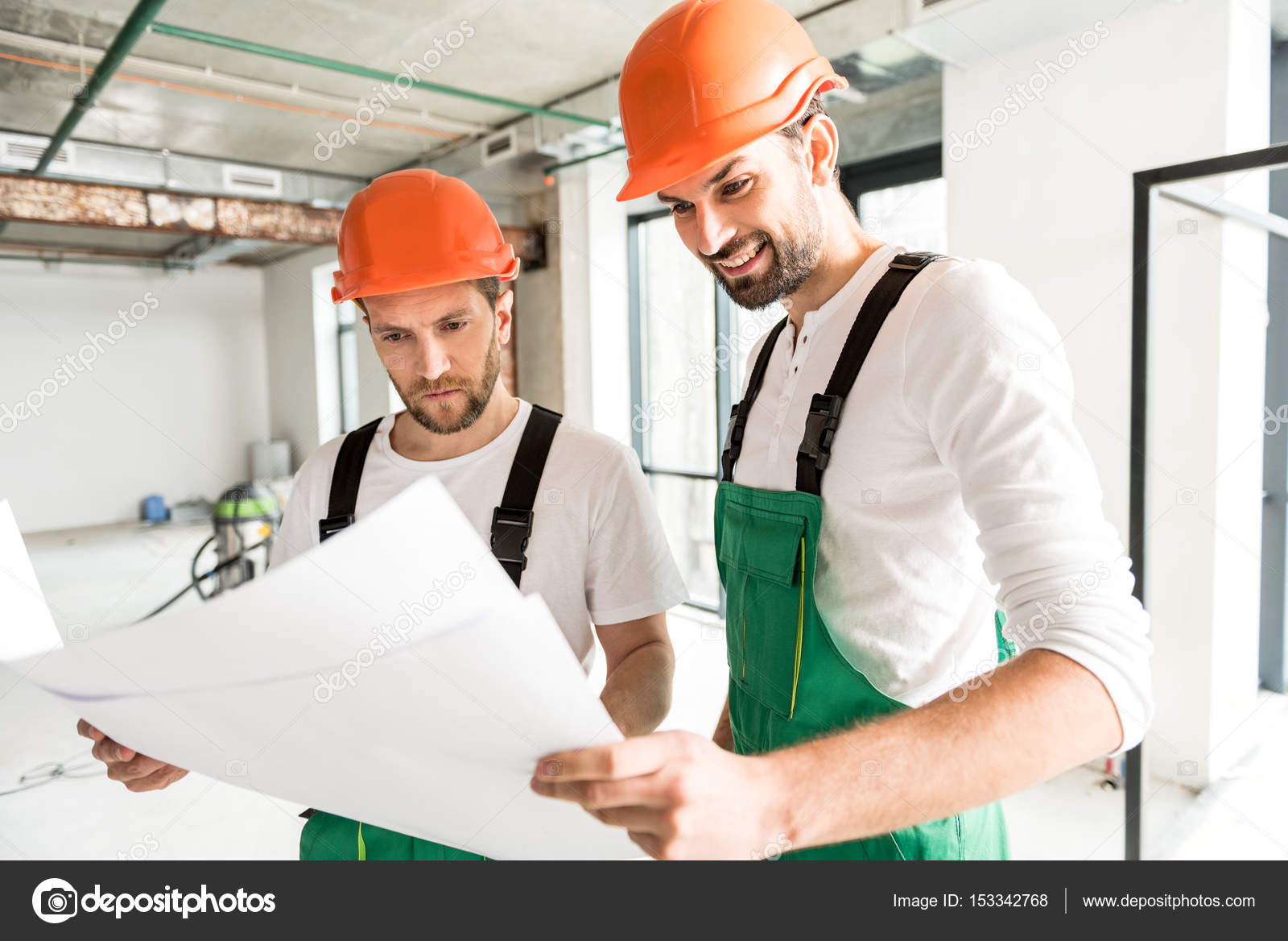 Concentrated constructors keeping special documents ⬇ Stock Photo ...