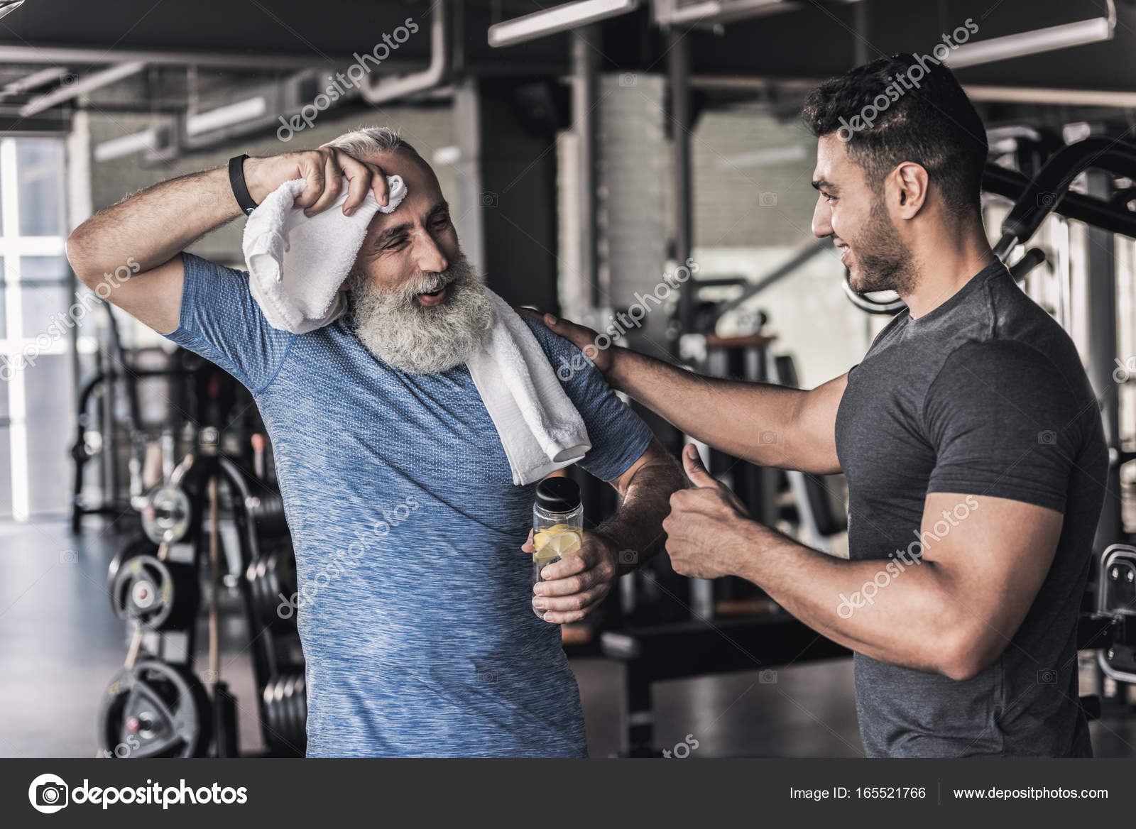Positive males are having friendly communication in modern gym Stock ...