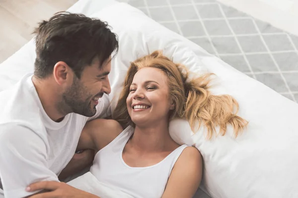 Happy loving couple having fun on bedding - Stock Image - Everypixel