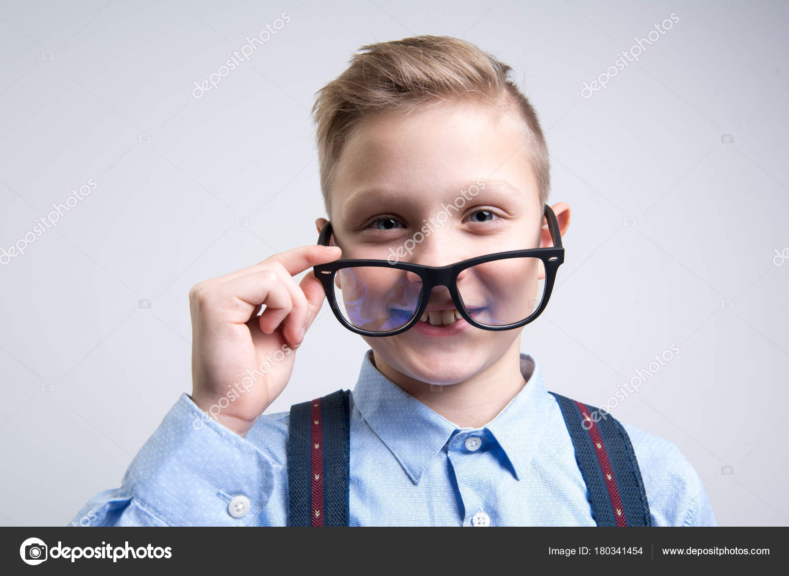Smart schoolchild putting on spectacles Stock Photo by ©iakovenko123 ...