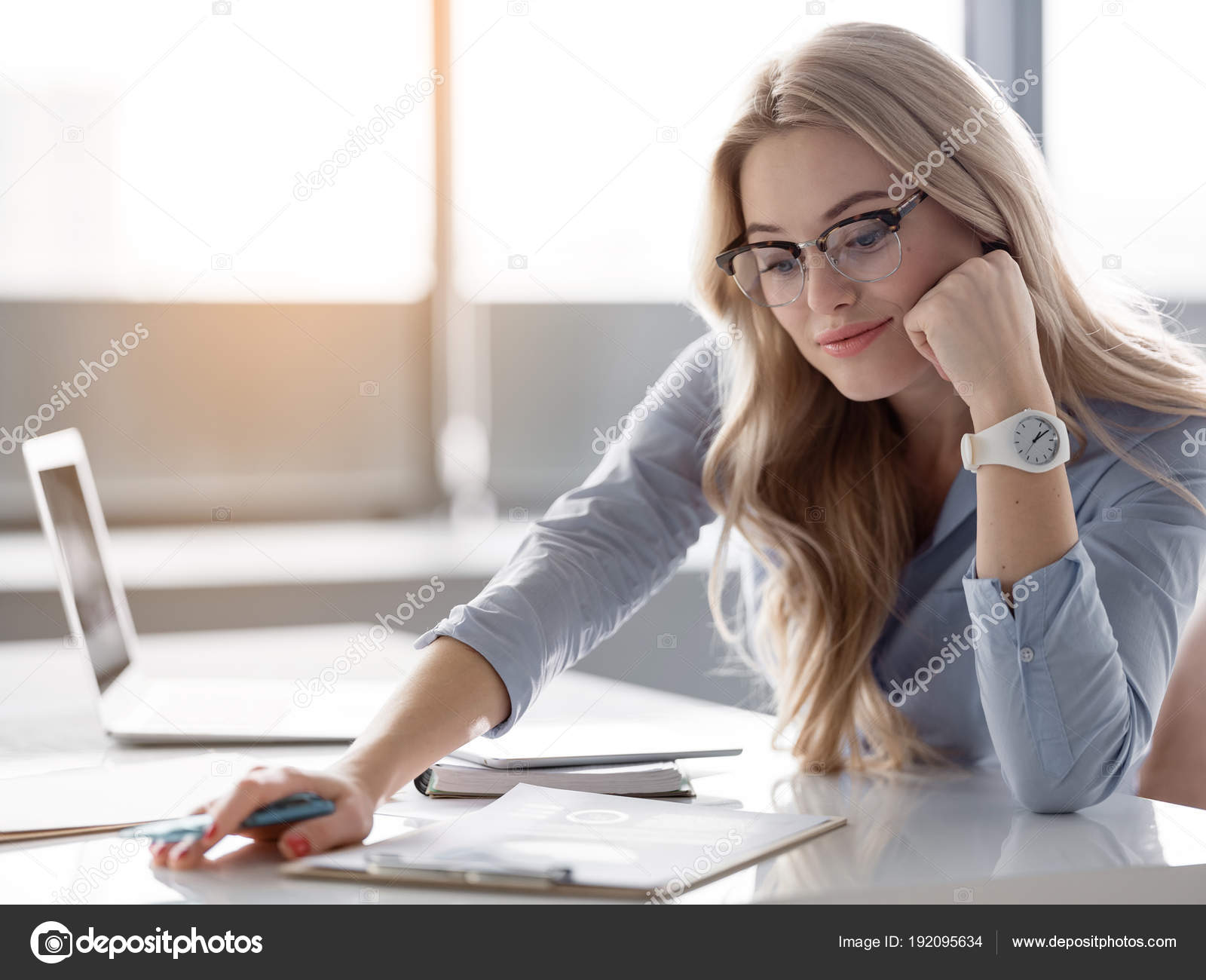 Cheerful blond woman analyzing papers at workplace — Stock Photo © iakovenko123 #192095634