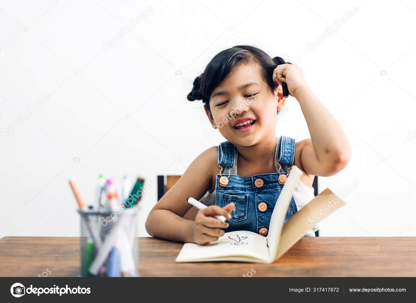 School kid little girl learning and writing in notebook with pen Stock ...