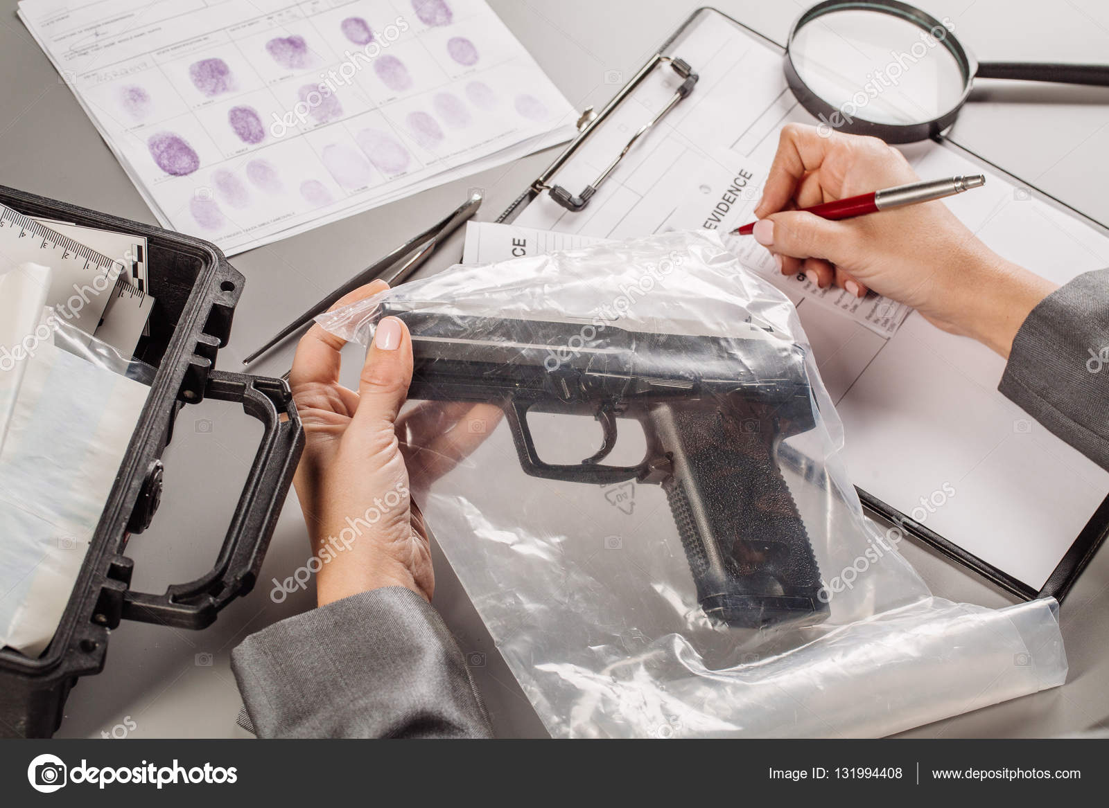 Detective through a magnifying glass looking at a evidence Stock Photo ...