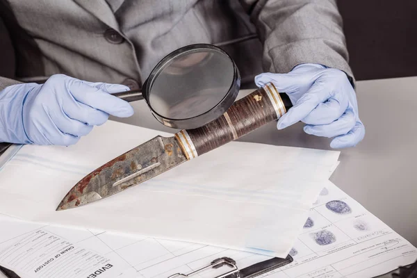 Detective through a magnifying glass looking at a evidence — Stock ...