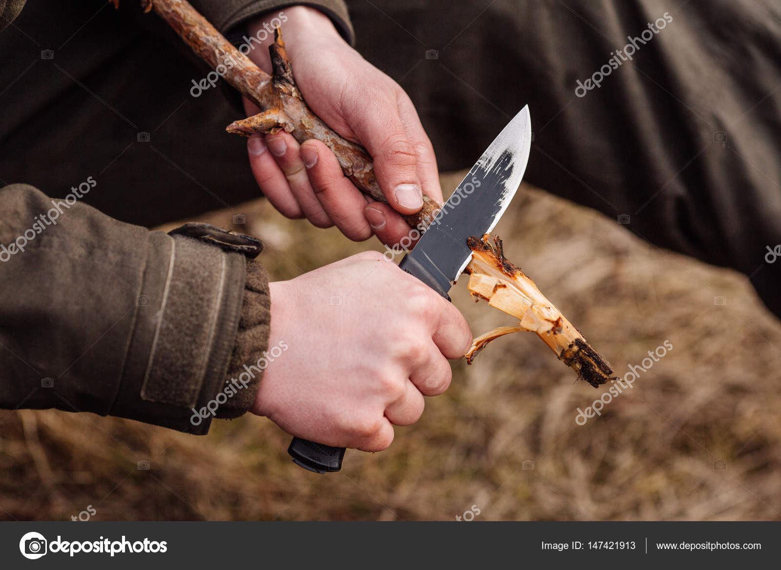 Close-up hand hunter man with knife cut a wooden stick — Stock Photo ...